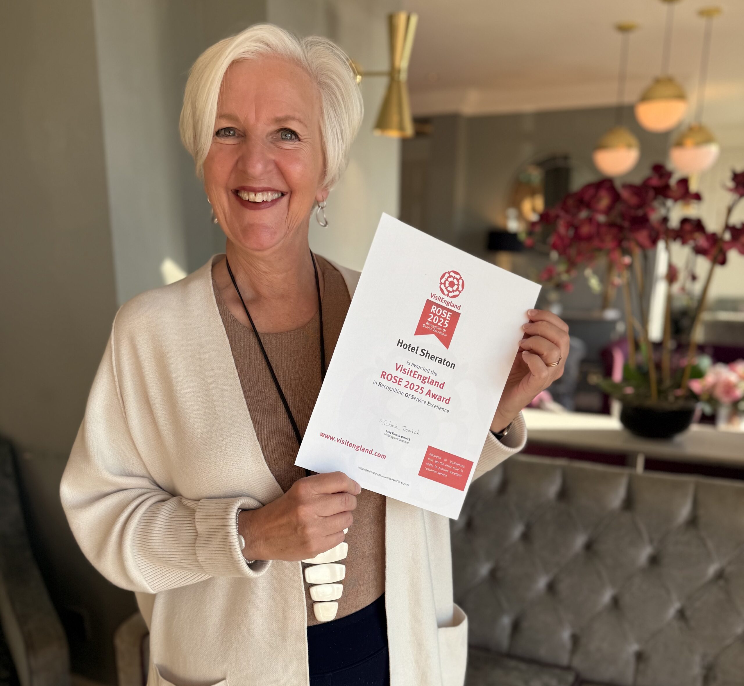 Liz proudly displays the ROSE Award certificate - Marketing Lancashire